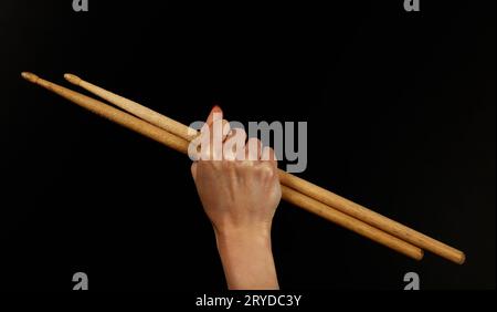 Close up woman hand with drumsticks over black Stock Photo - Alamy