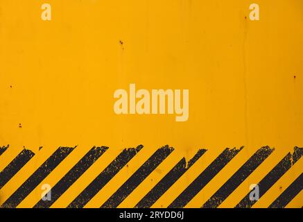 Yellow background with black grunge hazard sign Stock Photo - Alamy