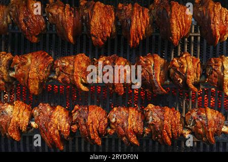 Pork knuckles slowly cooked at rotation grill Stock Photo - Alamy