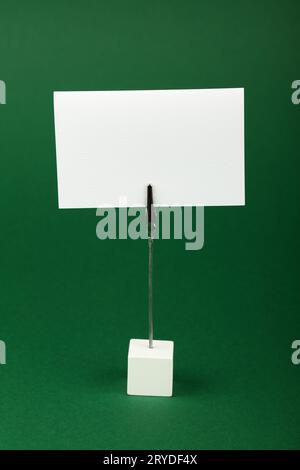 Blank white paper sign over green background Stock Photo - Alamy