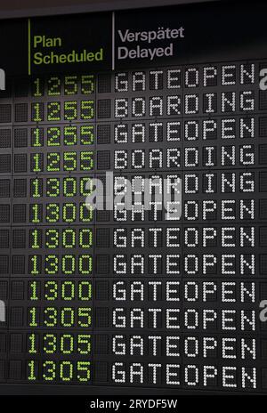 Flight information panel desk at airport, with time, flight number ...