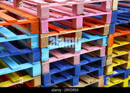 Stack of many multicolor painted wooden pallets Stock Photo - Alamy