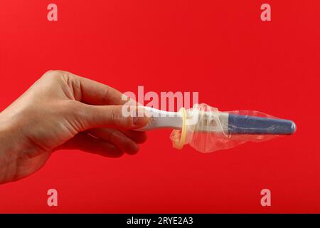 Woman holding condom Stock Photo - Alamy