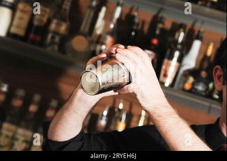 a barkeeper or bartender mixing drinks together in a bar barkeeper ...