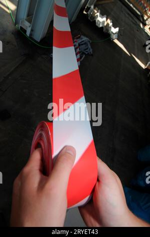 Red and white striped barrier tape Stock Photo - Alamy