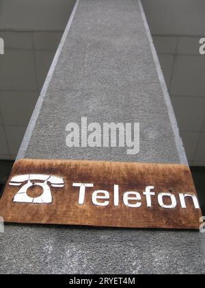 Landline telephone symbol, white, brown background Stock Photo - Alamy