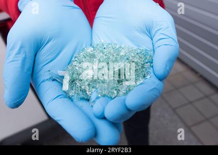 Person holding glass splinters in their hands Stock Photo - Alamy