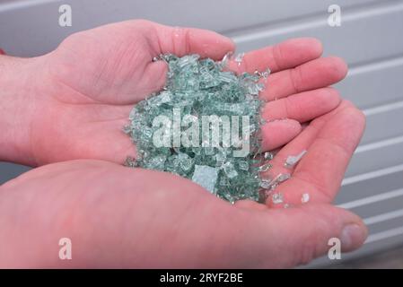 Person holding glass splinters in their hands Stock Photo - Alamy
