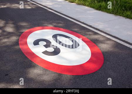 30 kilometers hour speed limit sign painted on city road Stock Photo ...