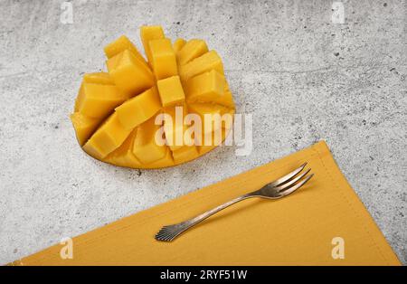 Close-up of diced half of mango, sliced red hot pepper and mango chili ...
