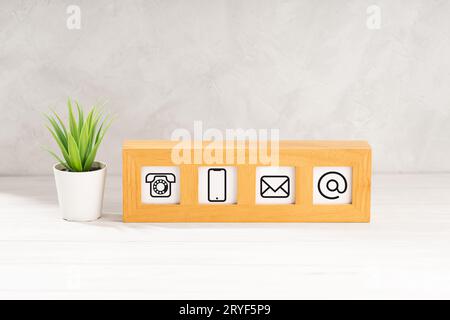 Contact us icons on white cube blocks. Copy space Stock Photo - Alamy