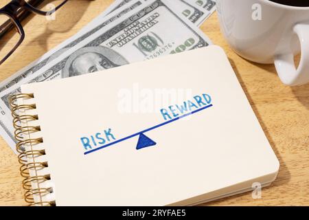 Risk reward concept. Drawing on notepad on desk Stock Photo - Alamy