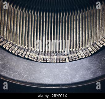 high angle view of typewriter machine near papers and glass of whiskey ...