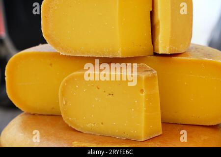 Close up cut slices and wheel of hard gouda cheese Stock Photo - Alamy