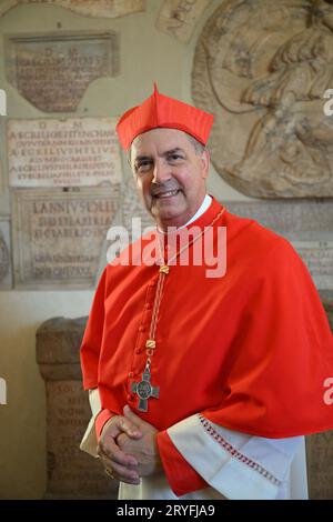 New cardinal Angel Fernandez Artime walks past Pope Francis during a ...
