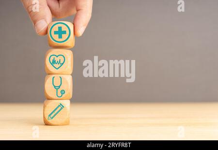 Hand hold wooden block with icon healthcare medical Stock Photo - Alamy
