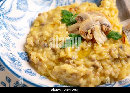 Italian risotto with mushrooms, saffron and parmesan cheese on dark ...