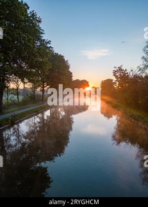 Drone view during sunrise over a farm hay field and river in Alberta ...