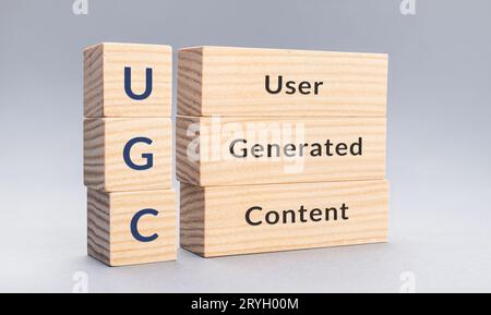 UGC User Generated Content text on wooden blocks on gray background ...