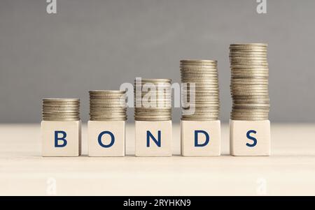 Bonds word on wood block with growing stacked coins. Bonds increasing ...