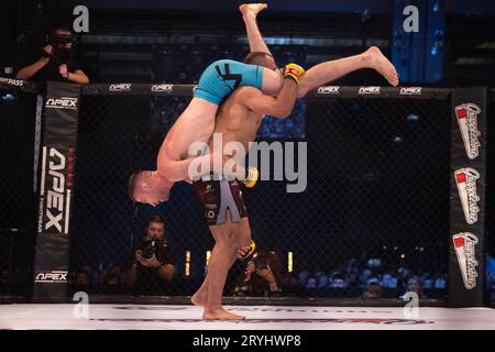 Matthew Camilleri (dark shorts) holds aloft Adam Shelley (blue shorts ...