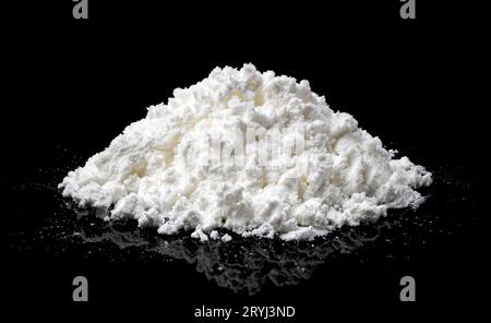 Pile of powdered milk isolated on black background Stock Photo - Alamy