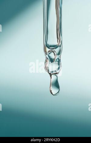 Scientific background: drop from pipette falling in a tube, text space ...