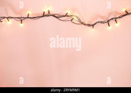 Yellow garland on a pink background. Holiday Christmas concept Stock ...