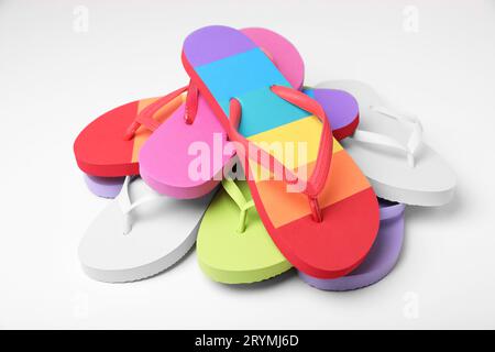 Different flip flops on white table against light blue background Stock ...