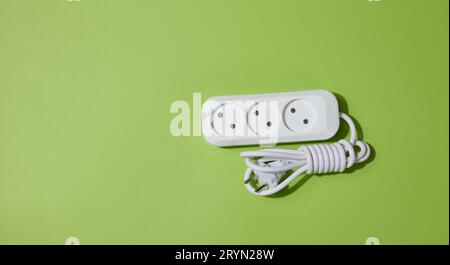 Top view of green socket and white electric power plug with line is ...