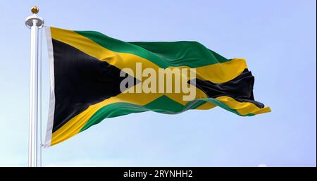 Jamaica national flag waving in the wind on a clear day. Gold saltire ...
