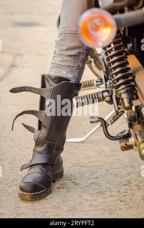 foot of a biker girl in a motorcycle boot sitting on a motorcycle Stock ...