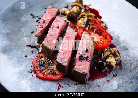Fried Italian chianina beef fillet steak very rare with mushrooms Stock ...