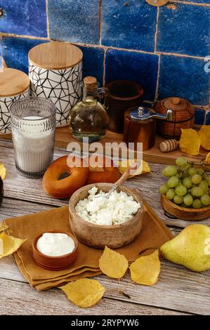 cottage cheese on clay dish with wooden spoon on kitchen tablecloth ...