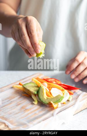Preparing vegetarian spring rolls on chop board. Picture of traditional ...