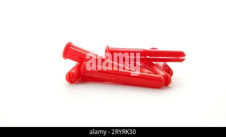Red plastic dowels isolated on white background Stock Photo - Alamy