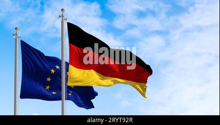The flags of Germany and the European Union waving together on a clear ...