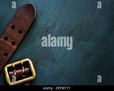 Leather brown belt on a dark background with reflection Stock Photo - Alamy
