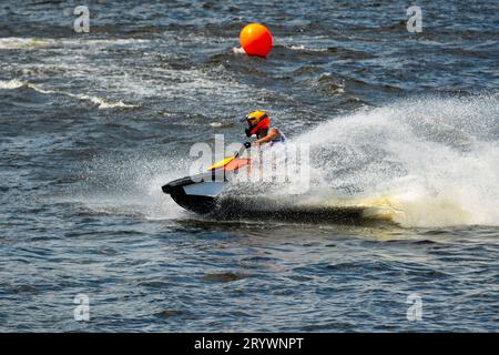 Jet ski driver in action during show with splashing water Stock Photo ...