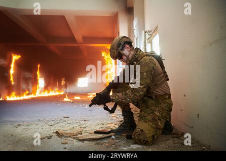 soldier in action near window changing magazine and take cover Stock ...
