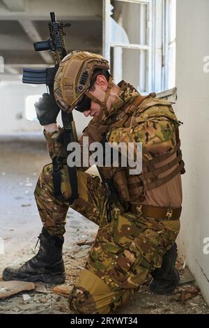 soldier in action near window changing magazine and take cover Stock ...