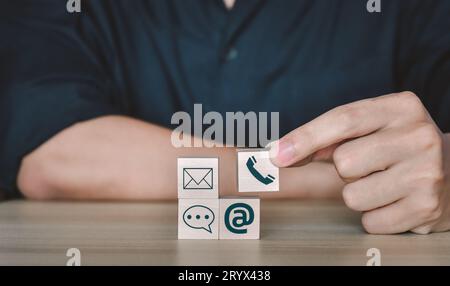 Hand holding a wooden cube with symbol of job loss concept Stock Photo ...