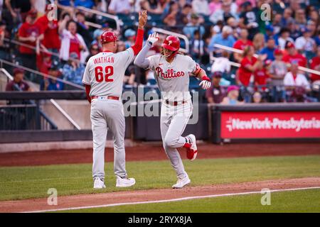 Philadelphia Phillies' Alec Bohm, right, high-fives third base coach ...