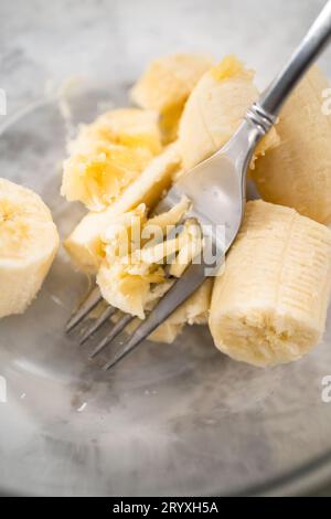 Mashing overhyped banana with a fork Stock Photo - Alamy