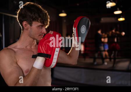 Portrait of boxer's training partner self-defense equipment must be ...