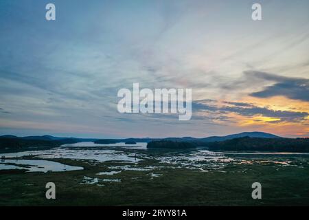 Sunset over Moody Tupper Lake NY Adirondacks in early fall aerial Stock ...