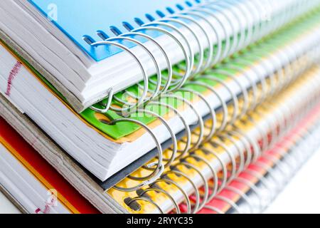 A stack of multi-colored notebooks on a spiral Stock Photo - Alamy