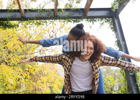 Happy diverse couple having fun slow dancing and smiling at each other ...
