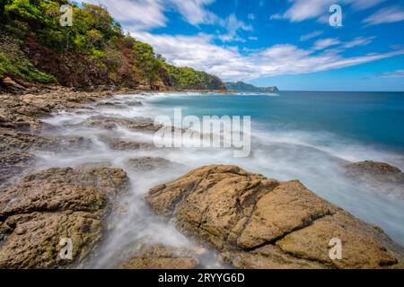 Playa Ocotal with Pacific ocean waves on rocky shore, El Coco Costa ...