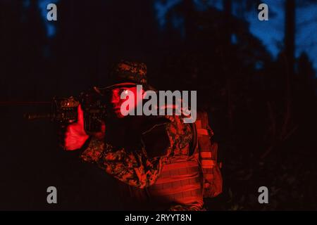 soldiers squad in action on night mission using laser sight beam lights ...